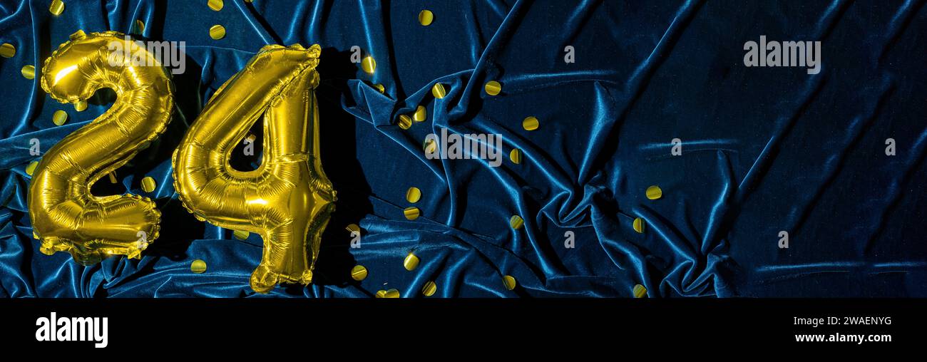number twenty four, gold foil balloon number on blue velvet background ...