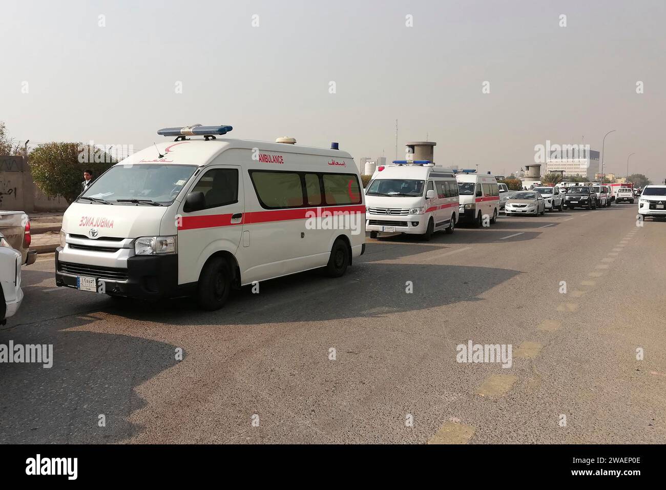 Ambulances line up in front of a headquarters of the Popular ...