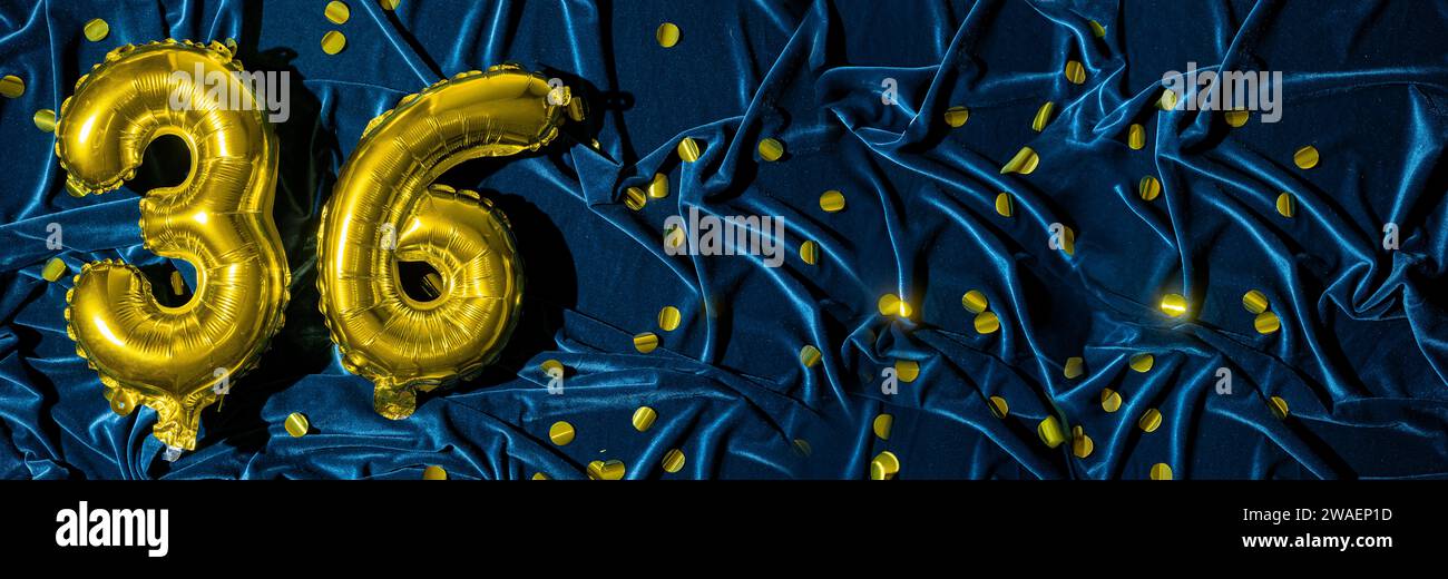 number thirty six, gold foil balloon number on blue velvet background ...