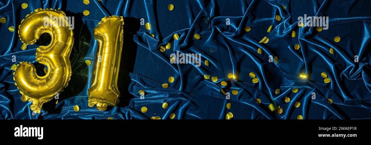 number thirty one, gold foil balloon number on blue velvet background ...