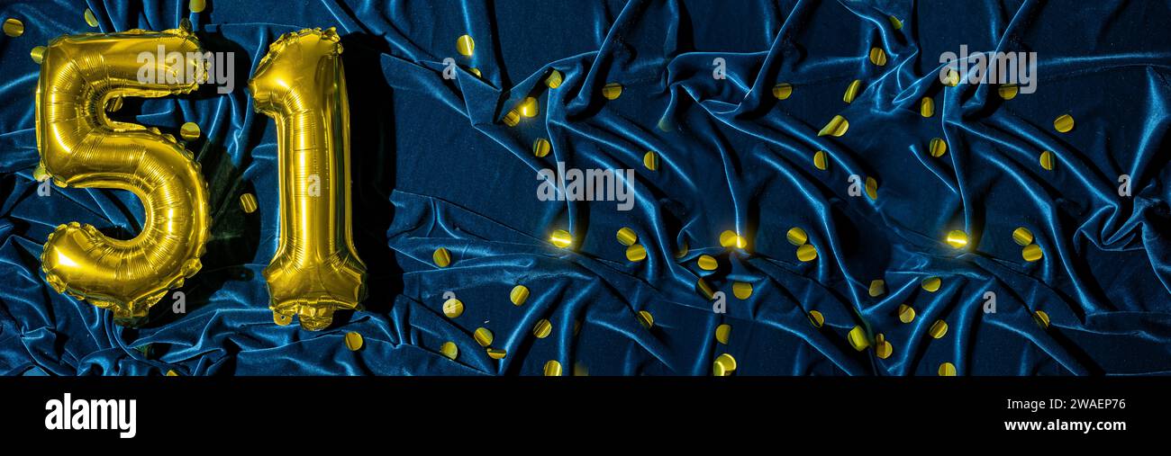 number fifty-one, gold foil balloon number on a blue velvet background ...