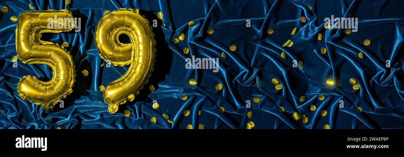 Gold foil balloon number number 59 on a background of blue velvet decoration. Birthday greeting ...
