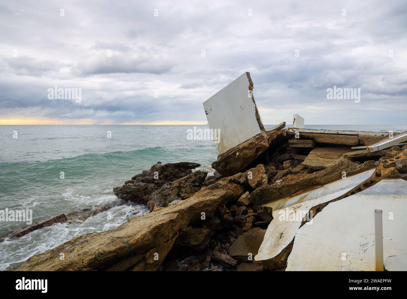A deserted beach on an island with the remains of a house, destroyed by ...