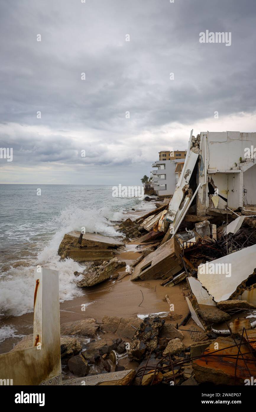 A deserted beach on an island with the remains of a house, destroyed by ...