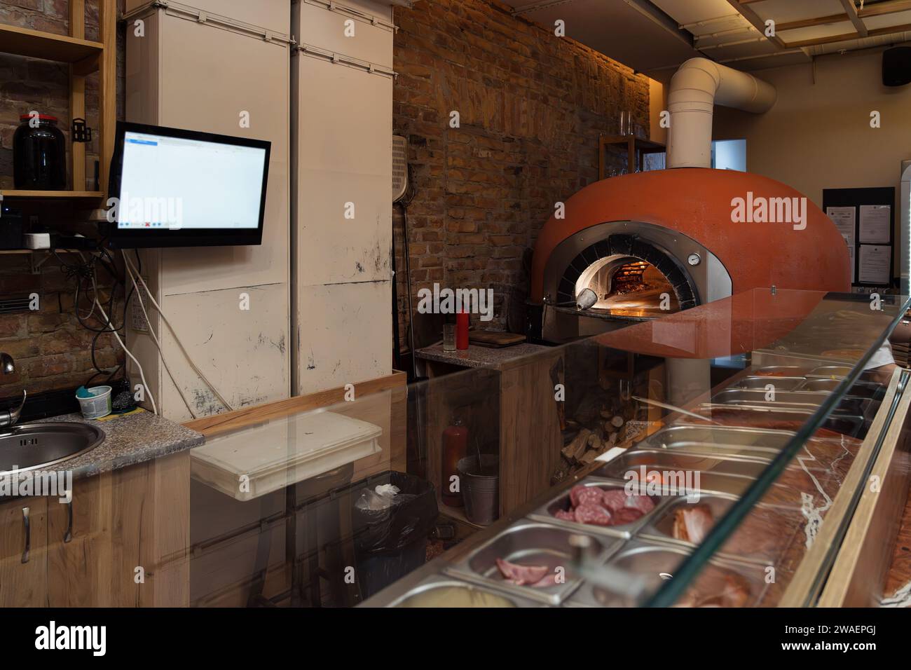 Inside a Pizzeria: Wood-Fired Oven and Topping Counter Stock Photo - Alamy