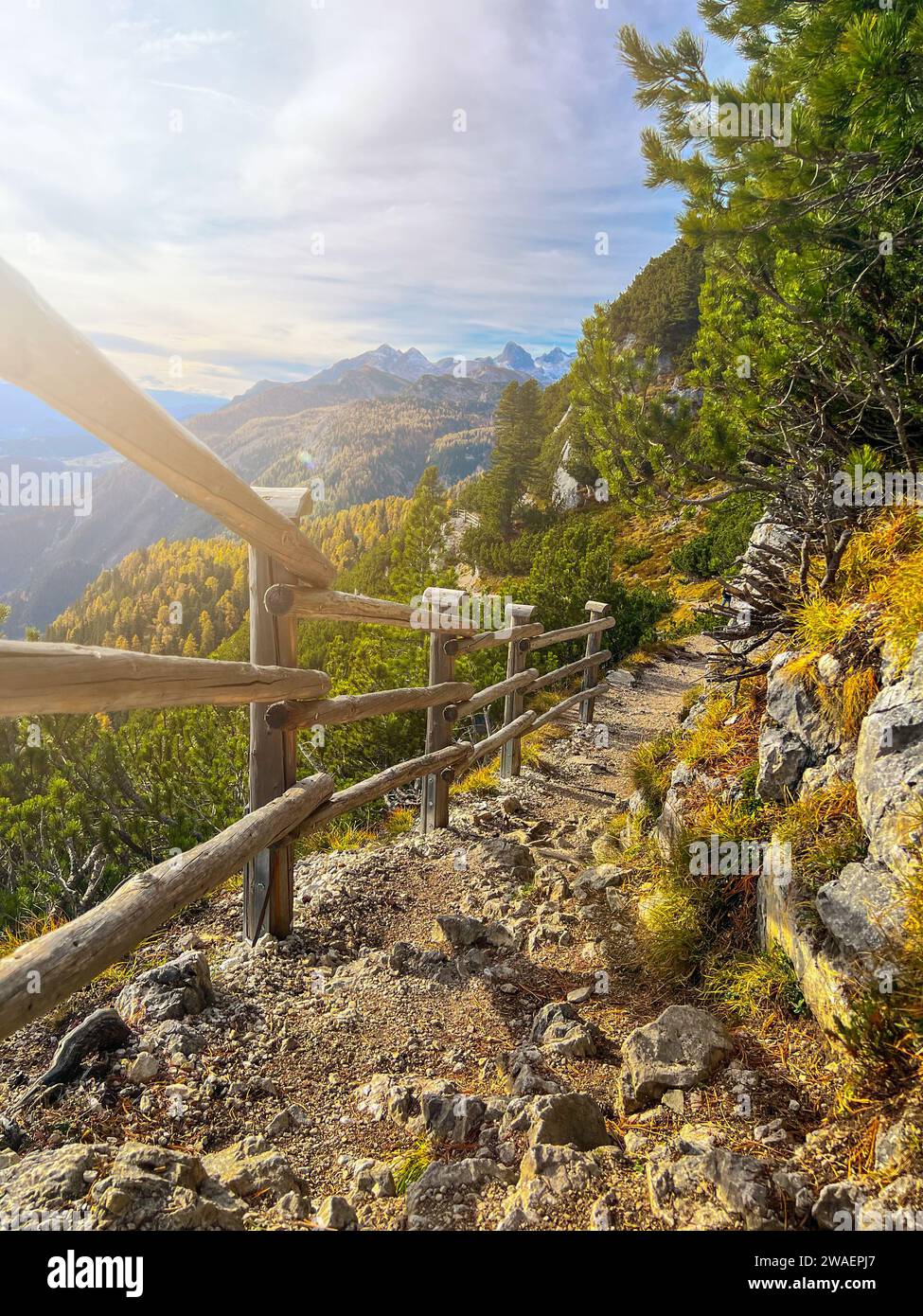 Narrow mountain path fortified with a small wooden fence Stock Photo ...