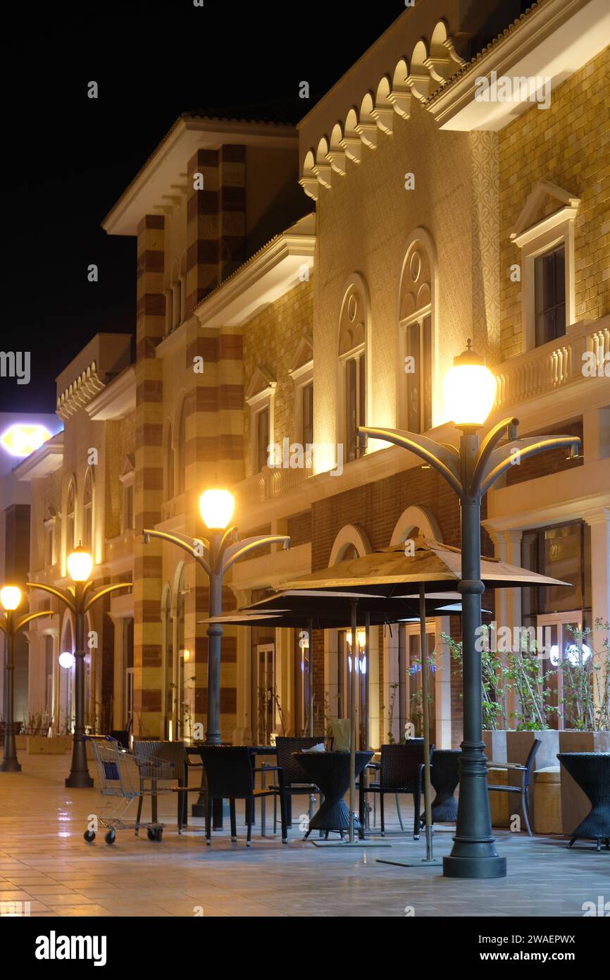 View of shopping street at night showing an outdoor seating area Stock ...
