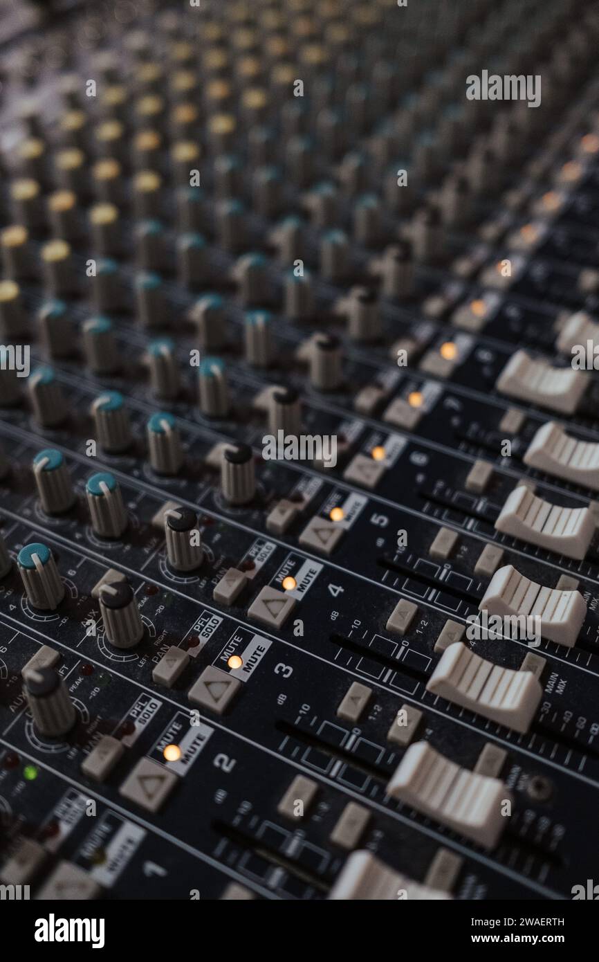 A vertical closeup of an analog audio mixer in a studio Stock Photo - Alamy