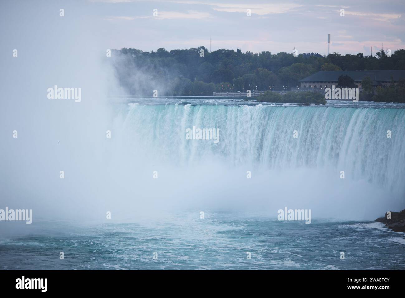 The powerful streams of Niagara Falls cascade down a river. Ontario ...