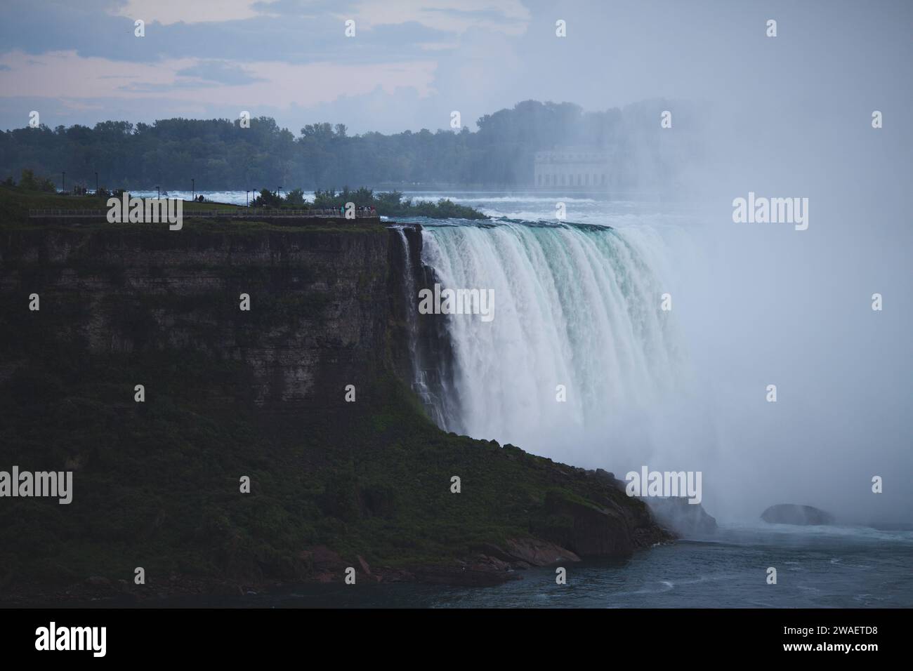 The powerful streams of Niagara Falls cascade down a river. Ontario ...