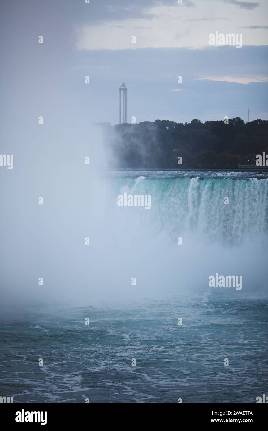 The powerful streams of Niagara Falls cascade down a river. Ontario ...