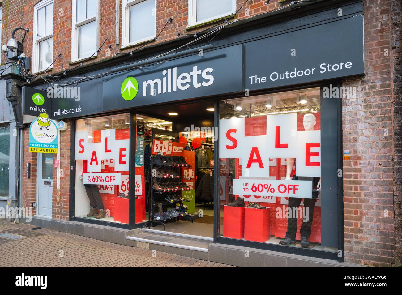 Millets outdoor clothing and equipment shop with sale notices in window ...