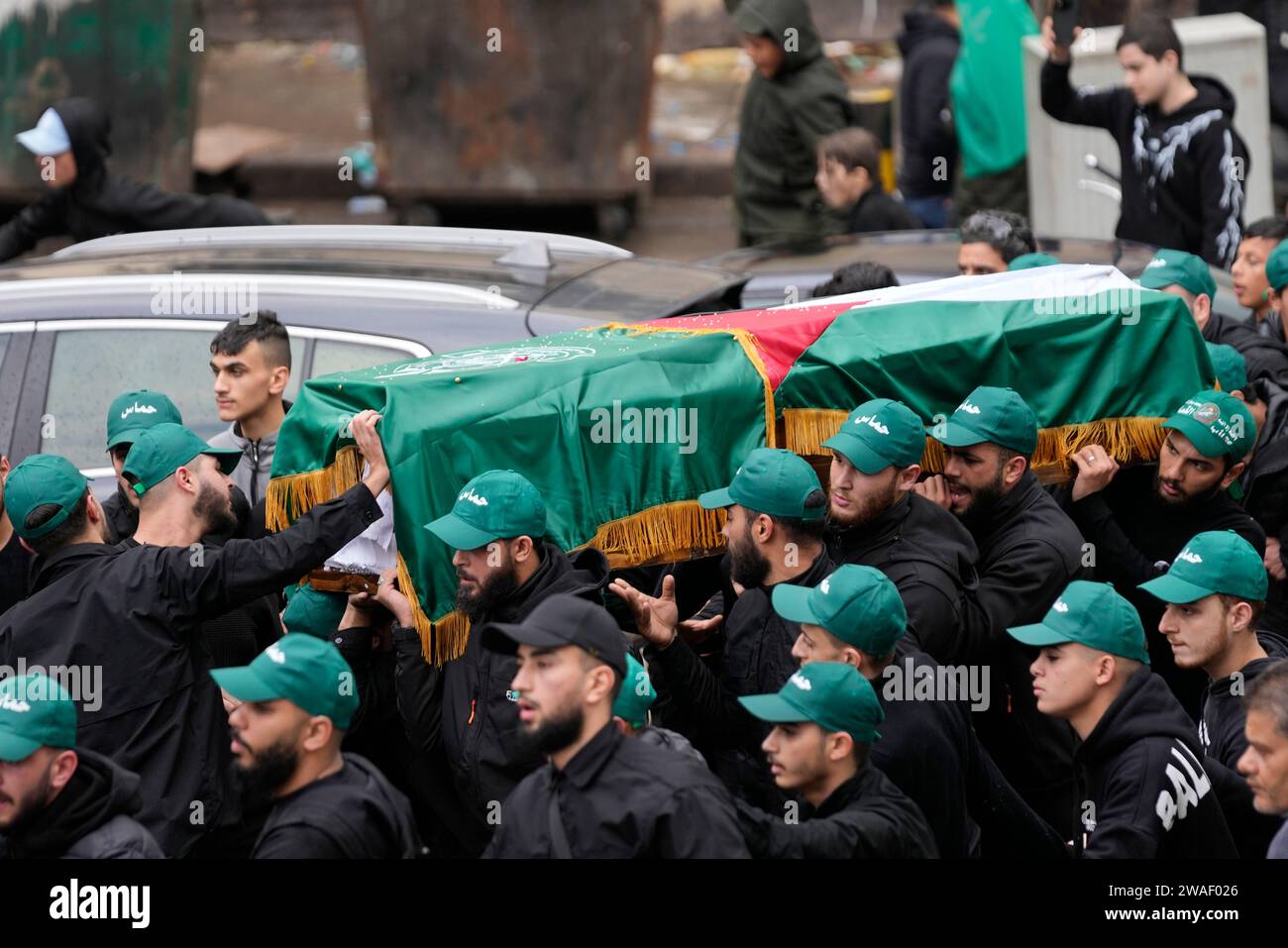 Hamas members carry the coffin of Mohammed al-Rayess, who was killed ...