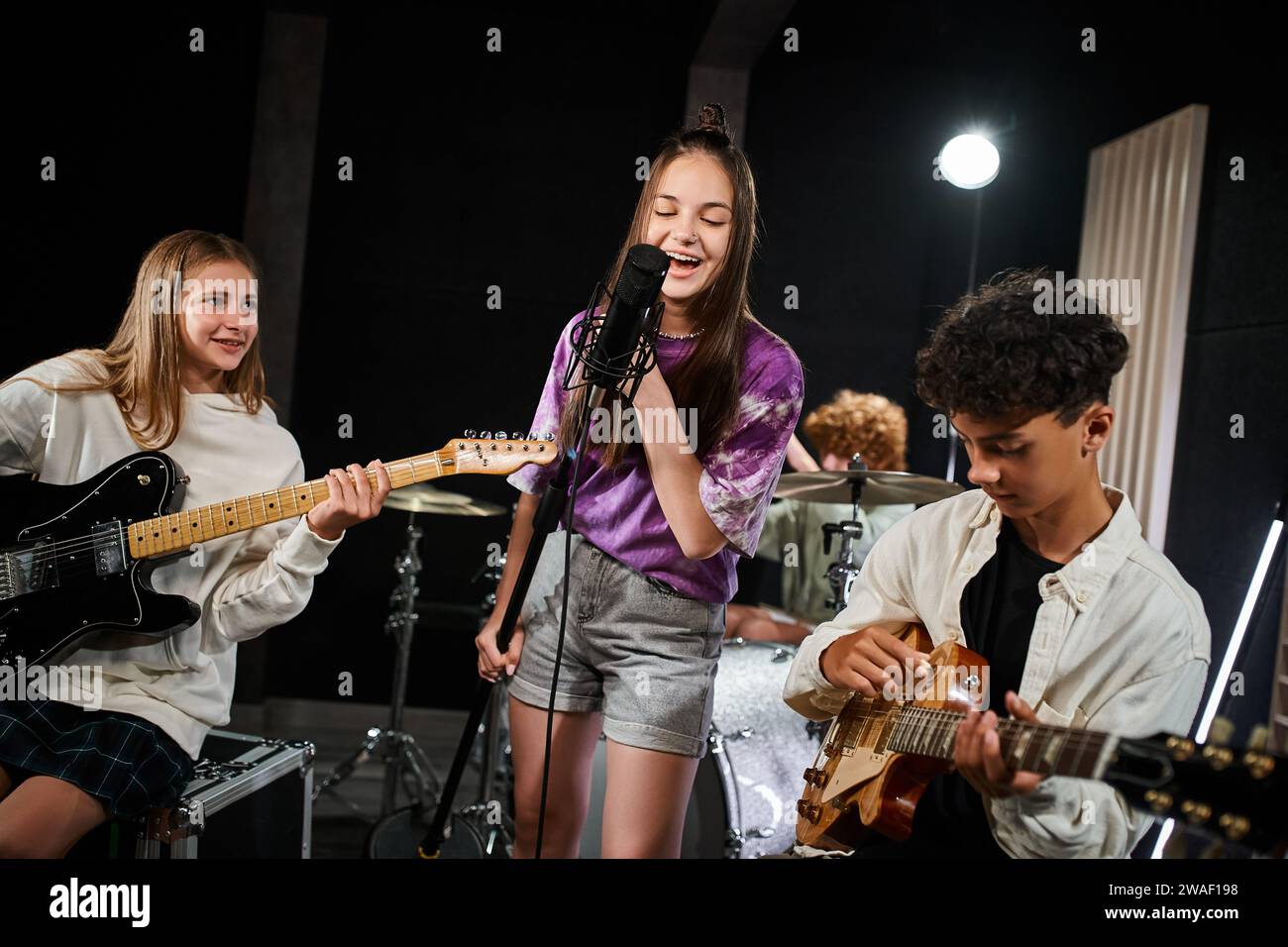cheerful adorable teenage band members singing and playing various ...