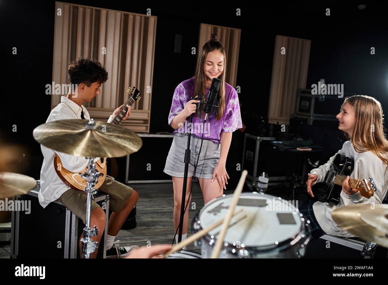 joyous talented teenage band members in casual attires singing and ...