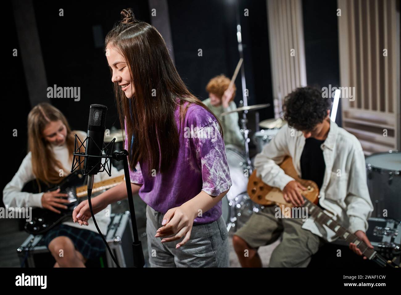 focus on jolly teenage girl singing while her friend playing various ...
