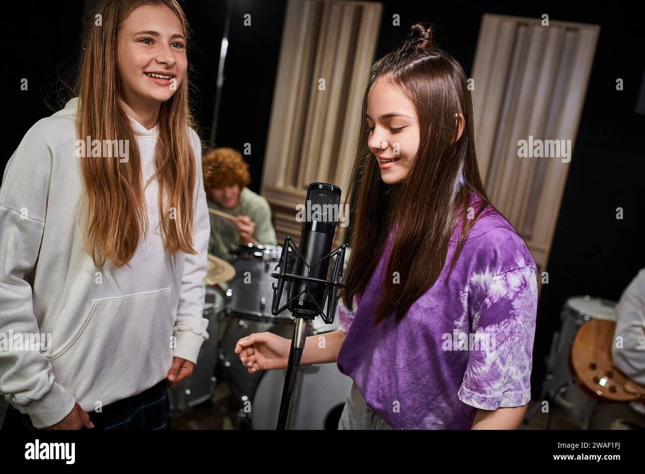 four adorable jolly teens singing and playing various instruments in ...