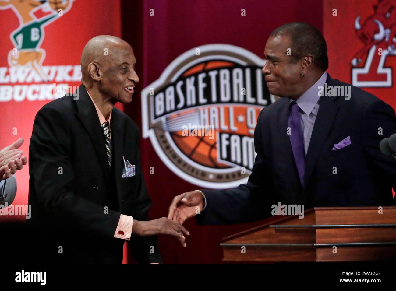 FILE - Inductee Dick Barnett, left, shakes hands with host Ahmad Rashad ...