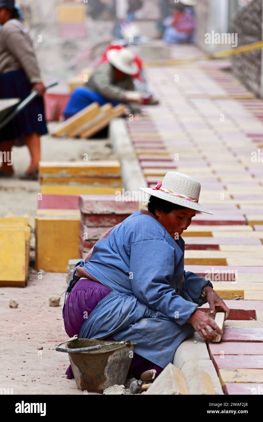 Local Quechua women working on a public works project laying a new ...