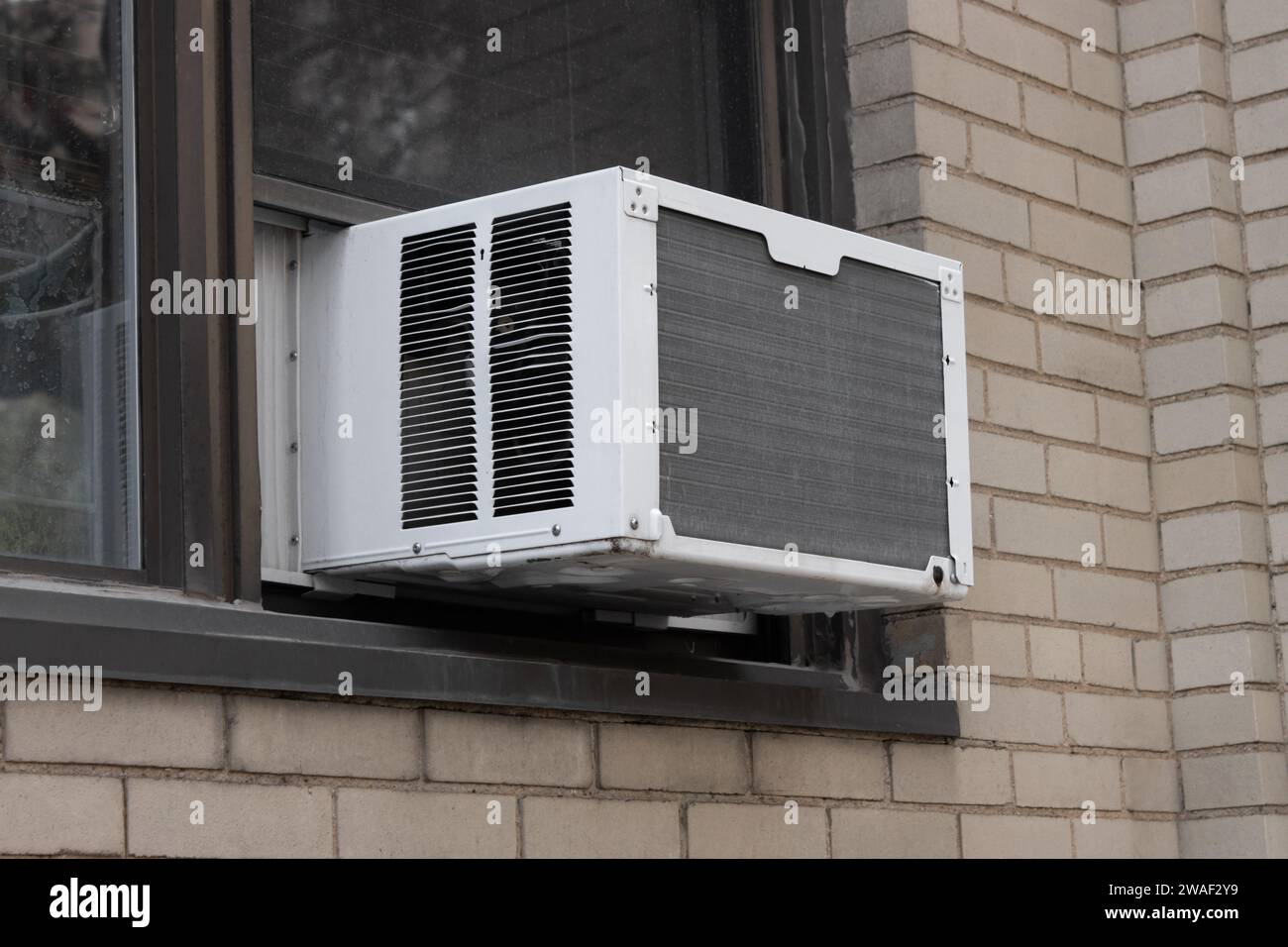 exterior view of air conditioning window unit extruding from the window ...