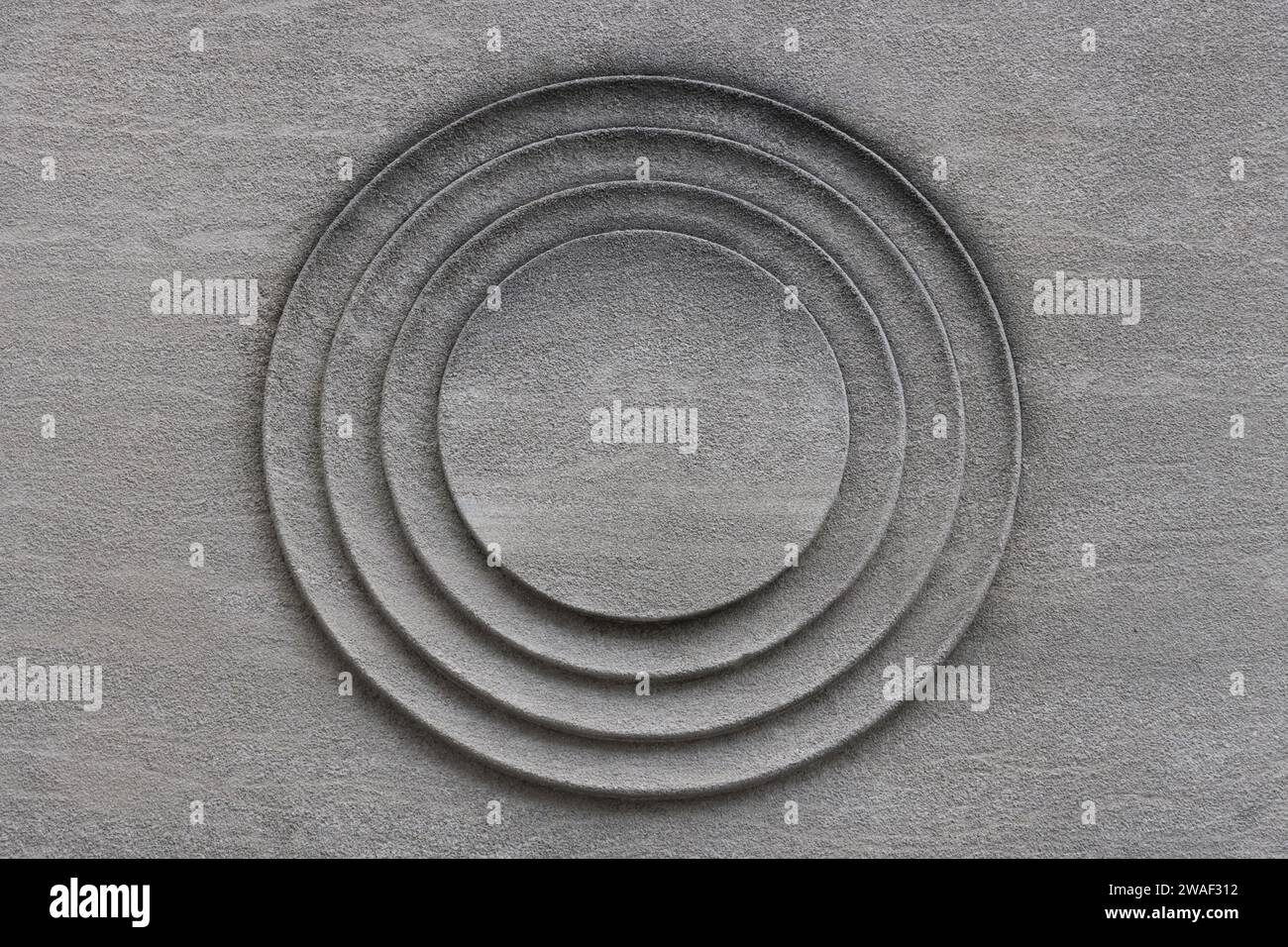 a circular medallion in concrete, a molded decorative architectural ...