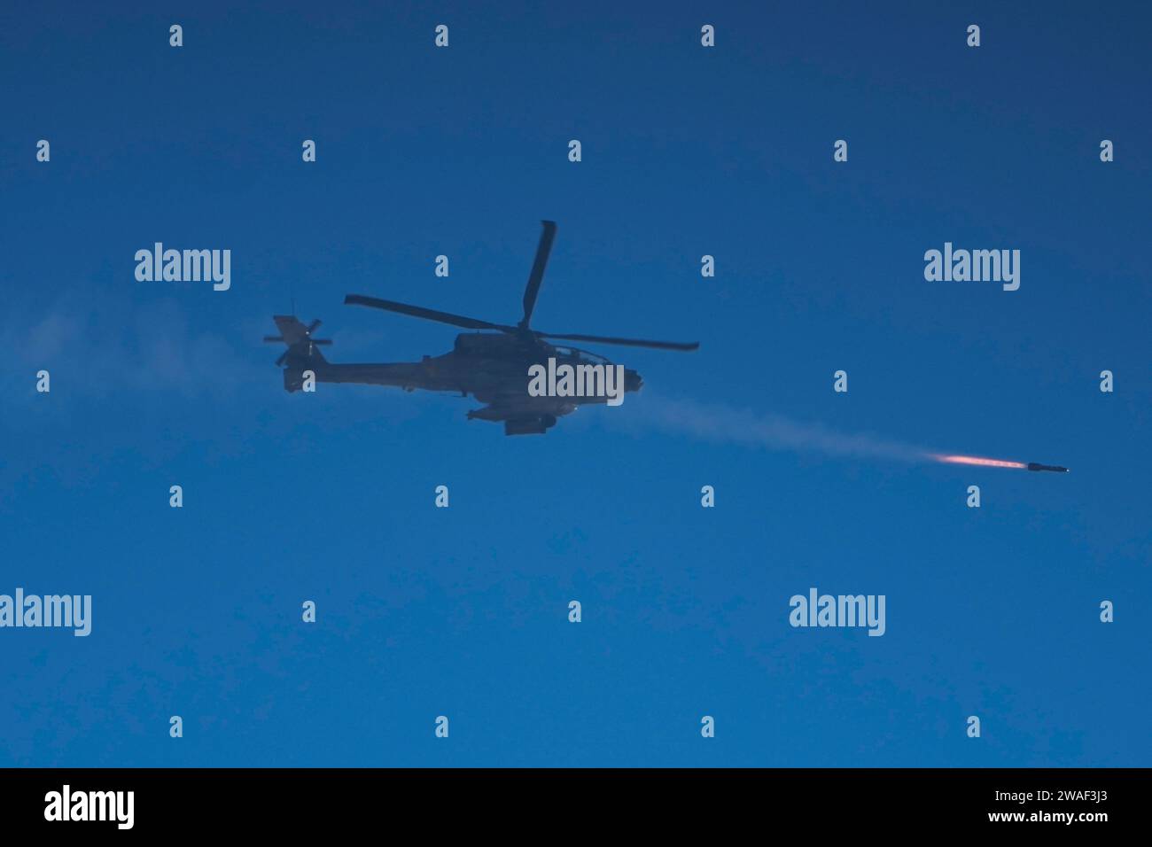 An Israeli Apache helicopter fires a missile in the direction of the ...