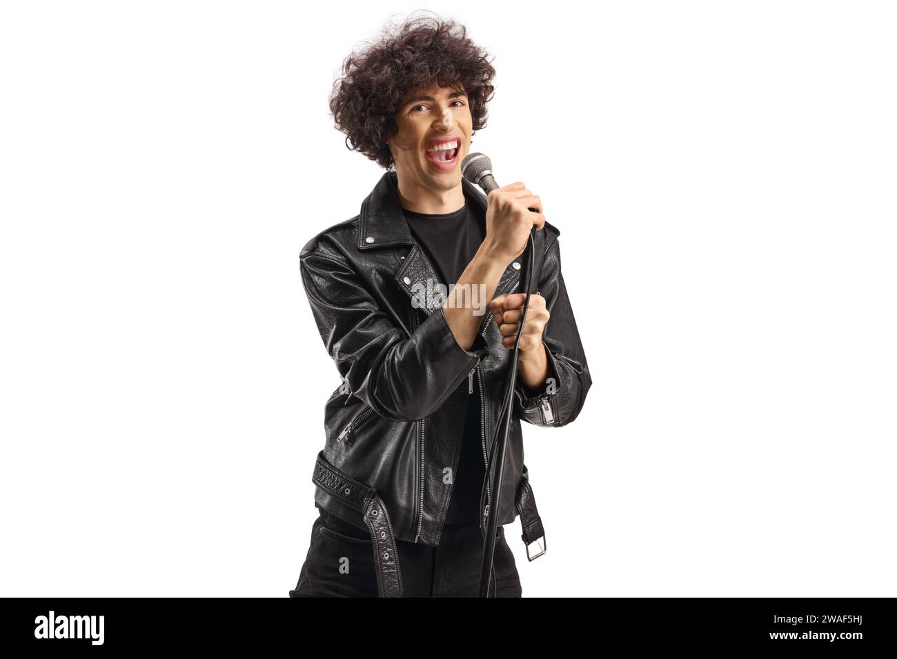 Young male singer in a leather jacket singing with a microphone ...