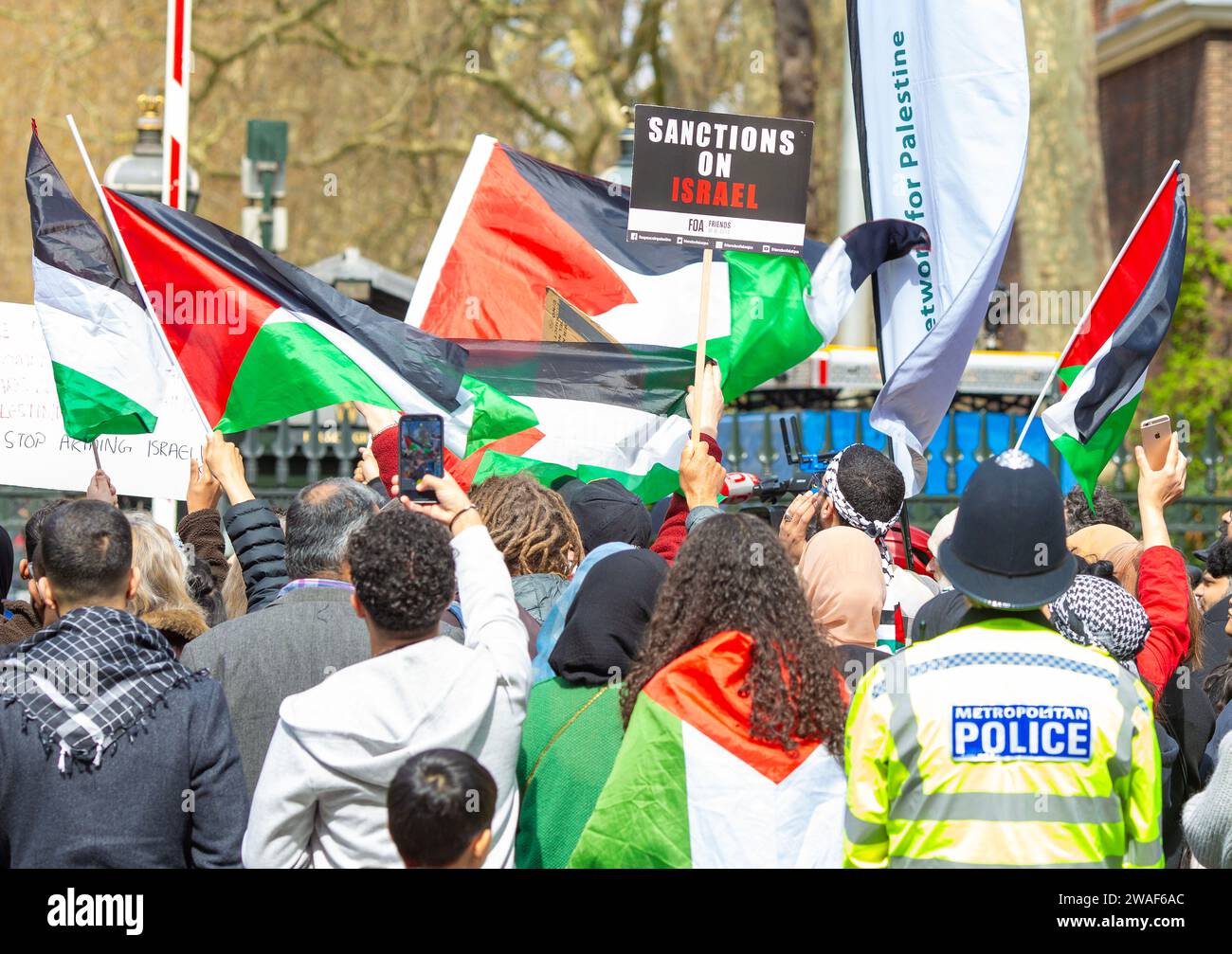 Pro-Palestinian protesters gather with flags and placards during a ...