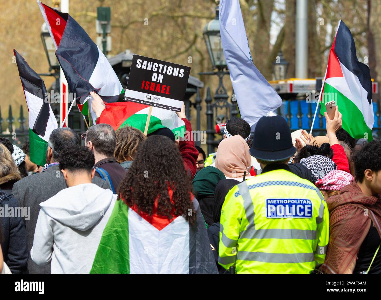 Pro-Palestinian protesters gather with flags and placards during a ...