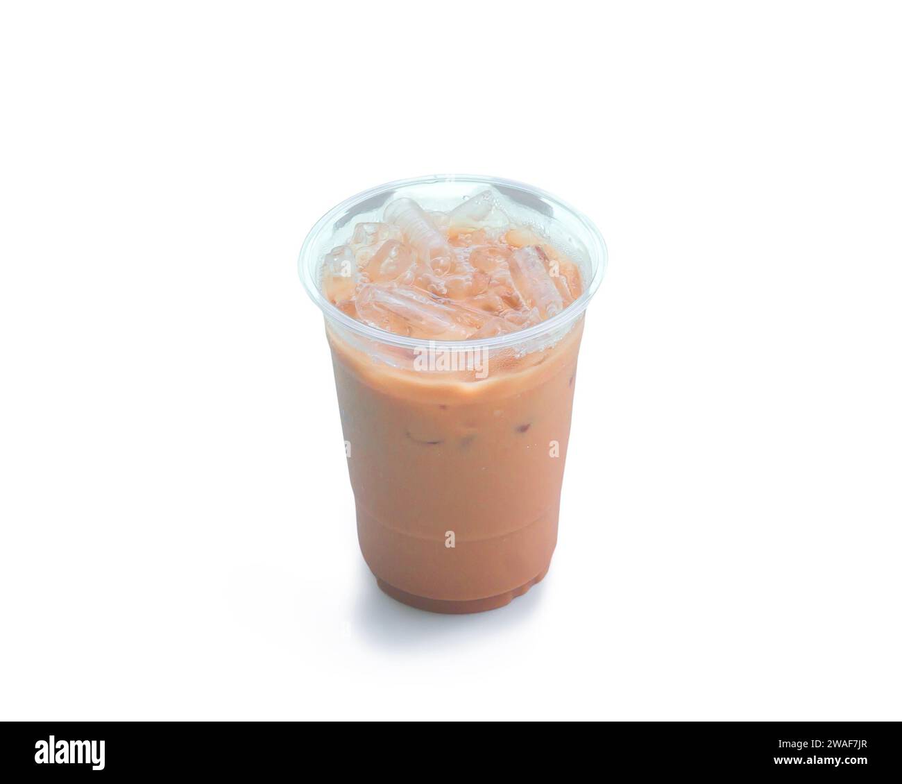 Orange Thai iced condensed milk tea in transparent plastic glass is ...