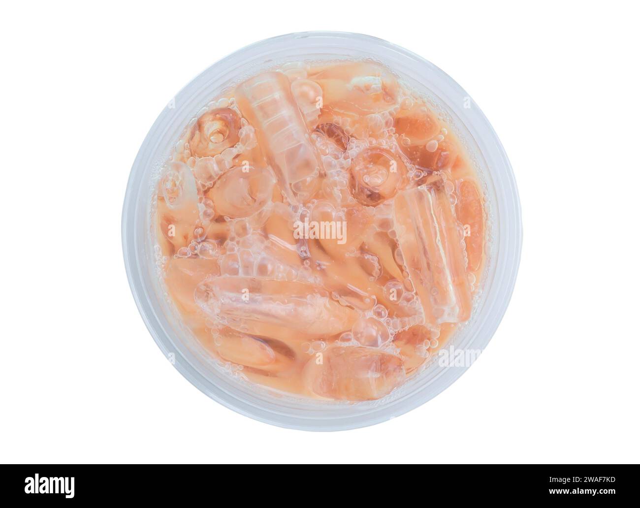 Top view of orange Thai iced condensed milk tea in transparent plastic ...