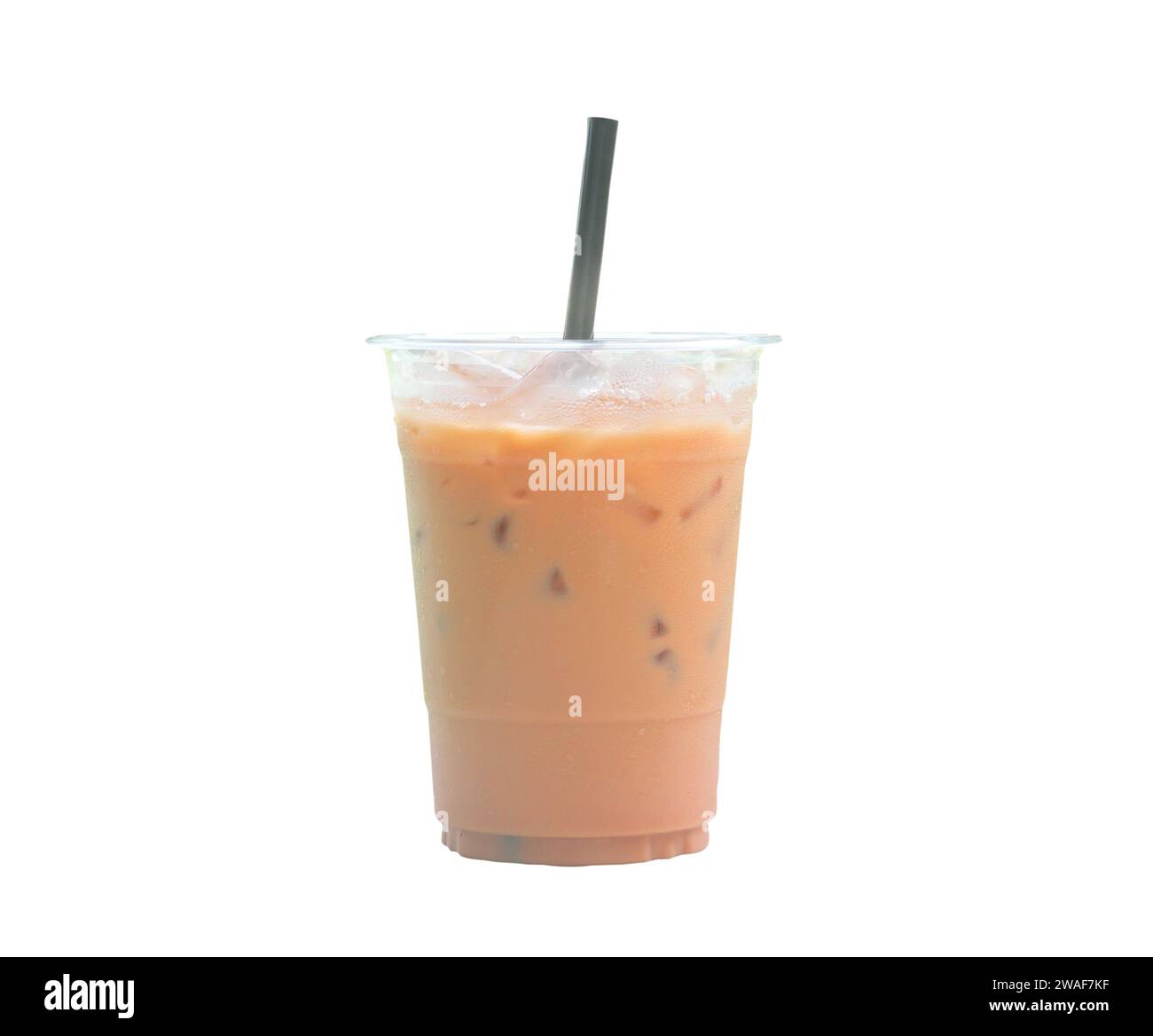 Orange Thai iced condensed milk tea in transparent plastic glass with ...