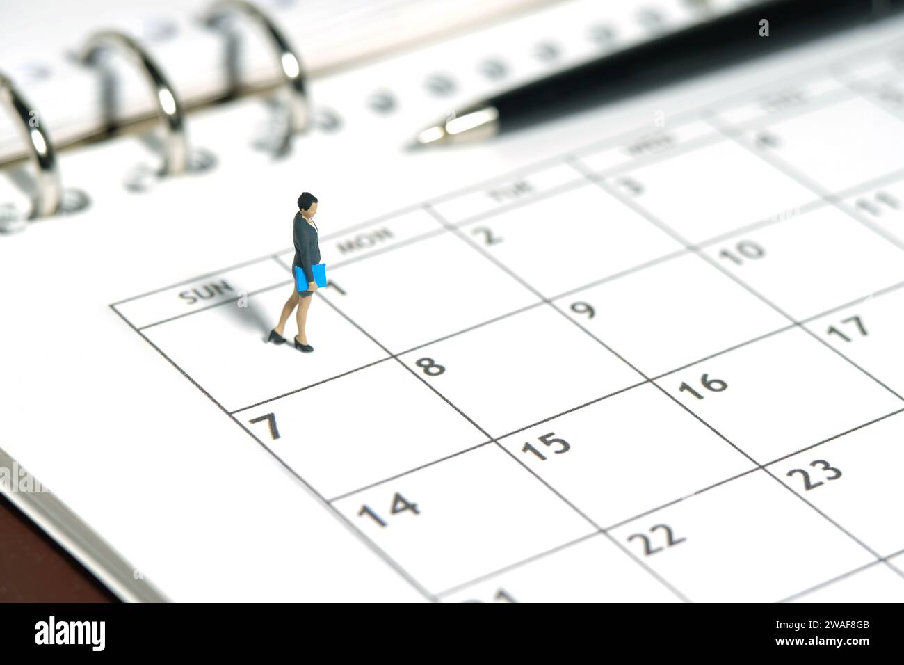 Miniature people toy figure photography. Work schedule concept. A ...