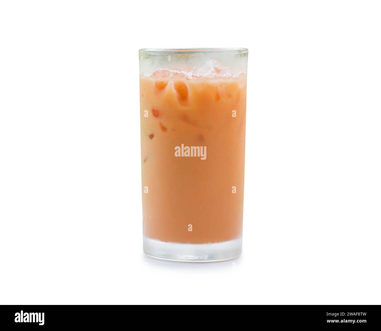 Orange Thai iced condensed milk tea in transparent glass is isolated on ...