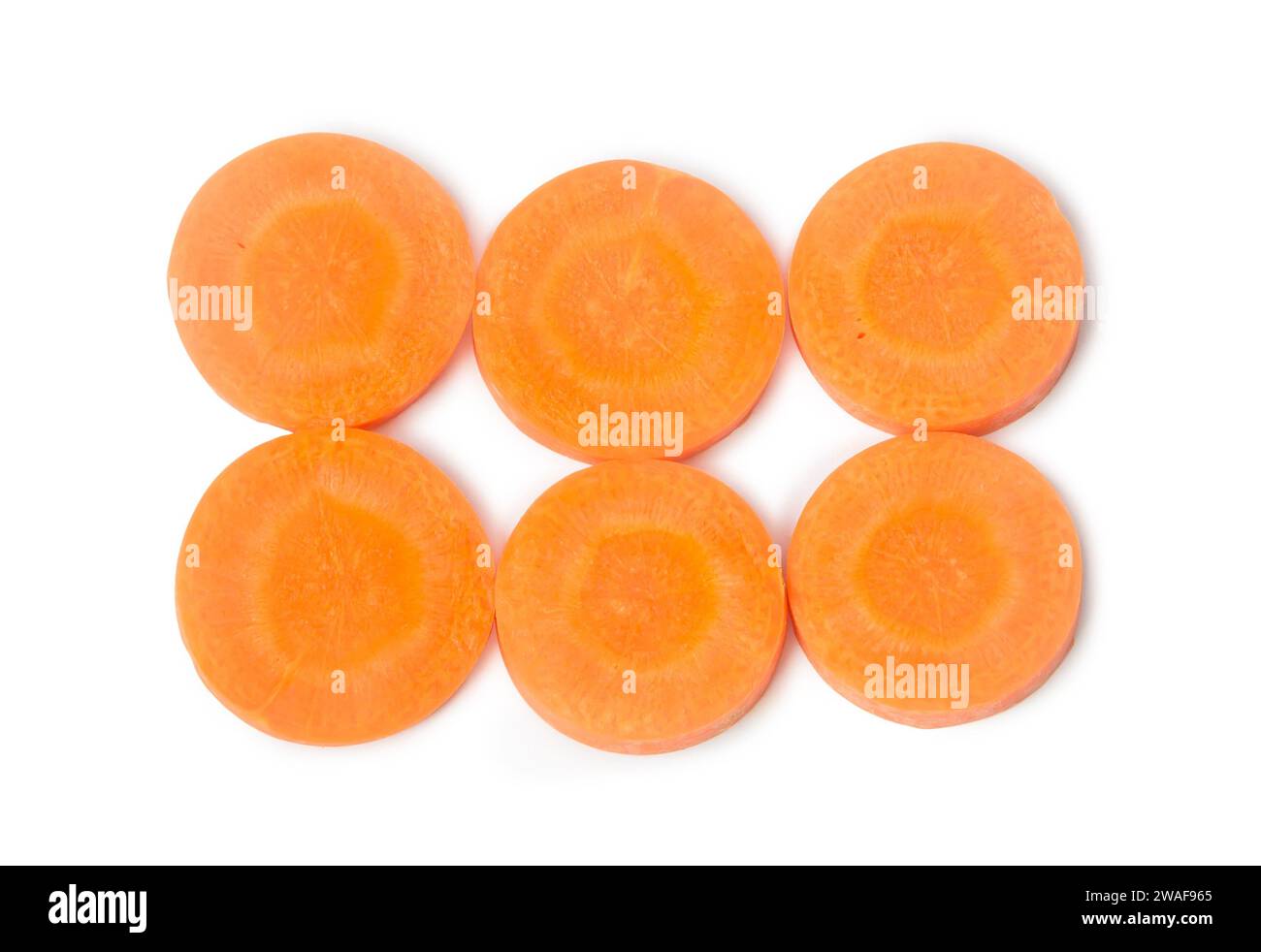 Fresh orange sliced carrots in stack are isolated on white background ...