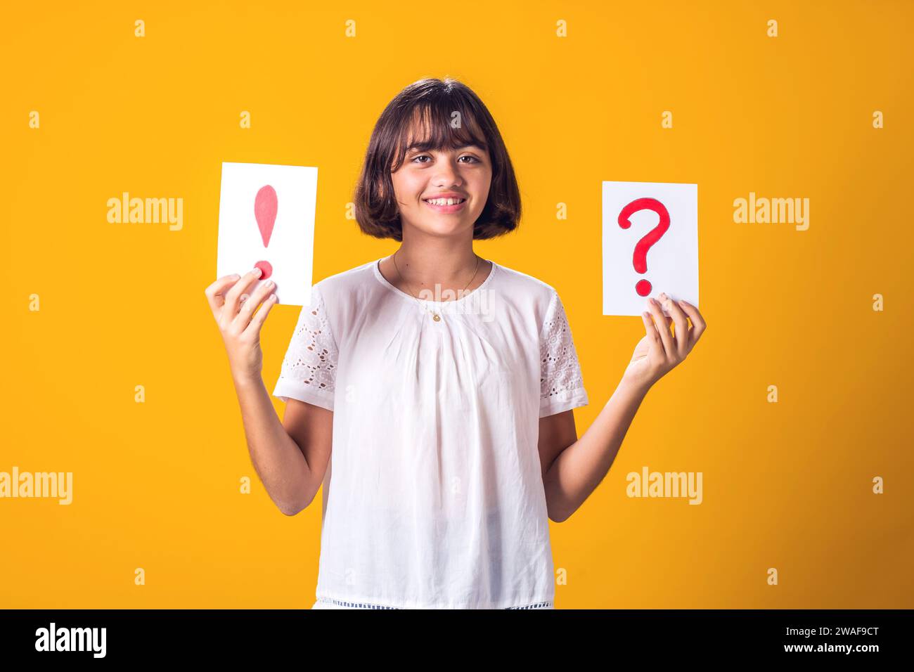 A portrain of kid girl holding cards with question mark and exclamation ...