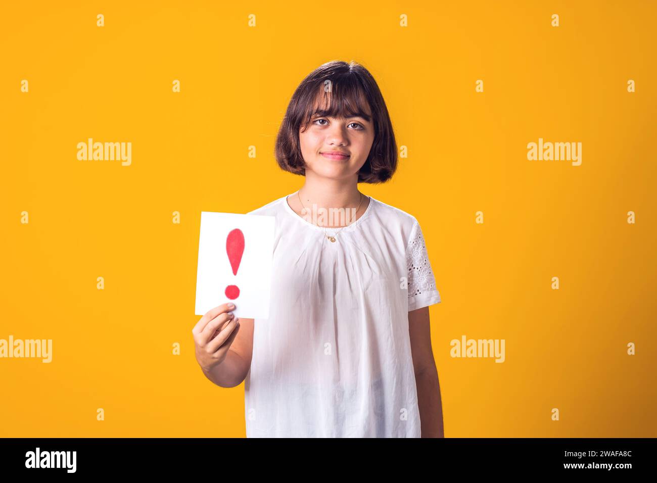 A portrain of kid girl holding exclamation point card. Children, idea ...