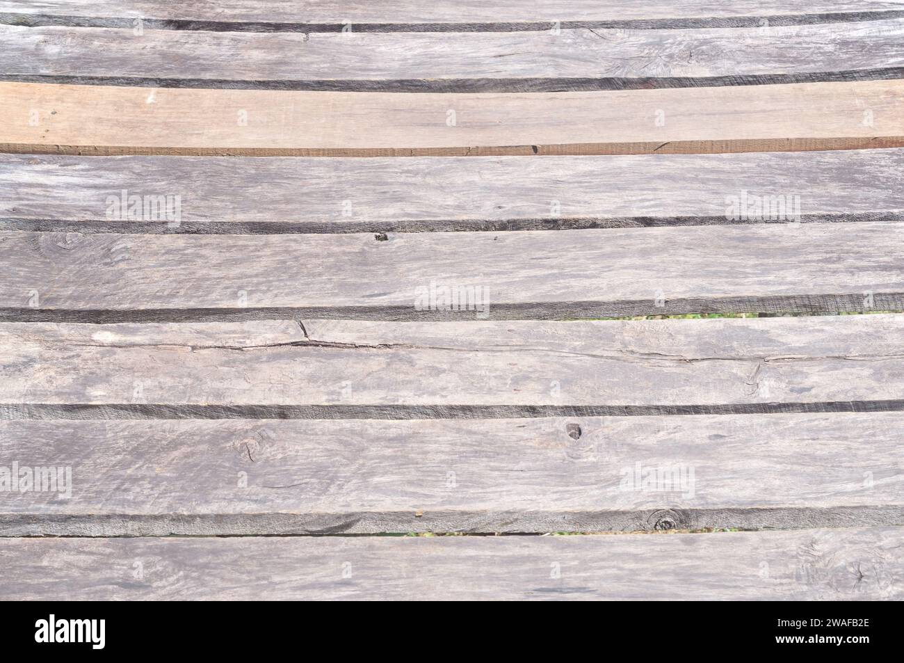 Weathered grey wood texture with cracked stripe on top is used for ...