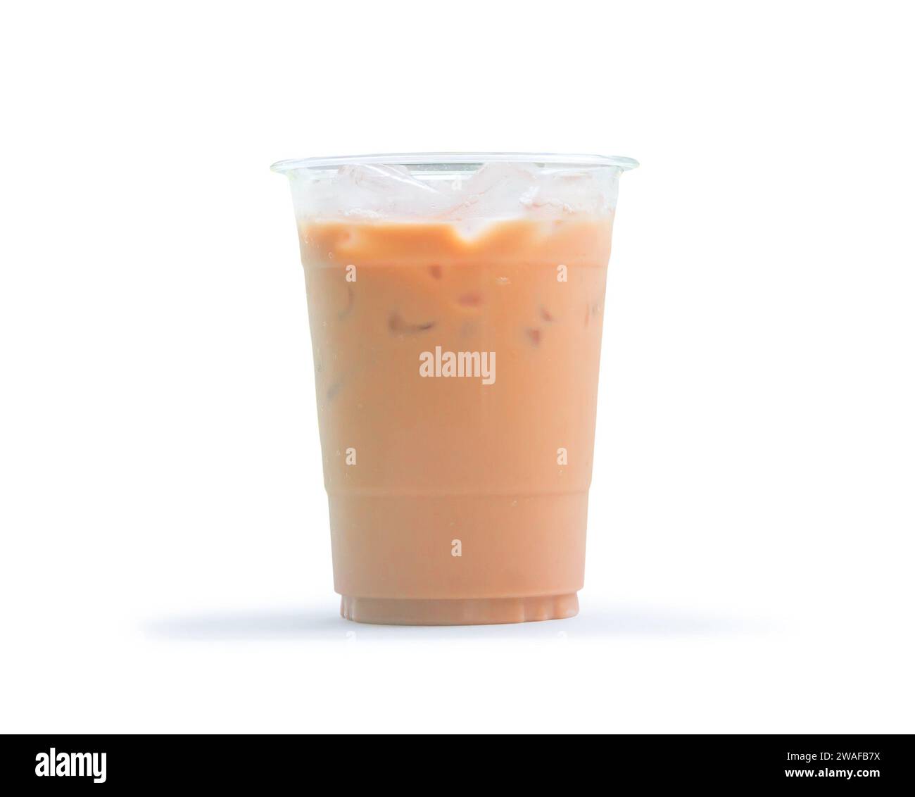 Orange Thai iced condensed milk tea in transparent plastic glass is ...