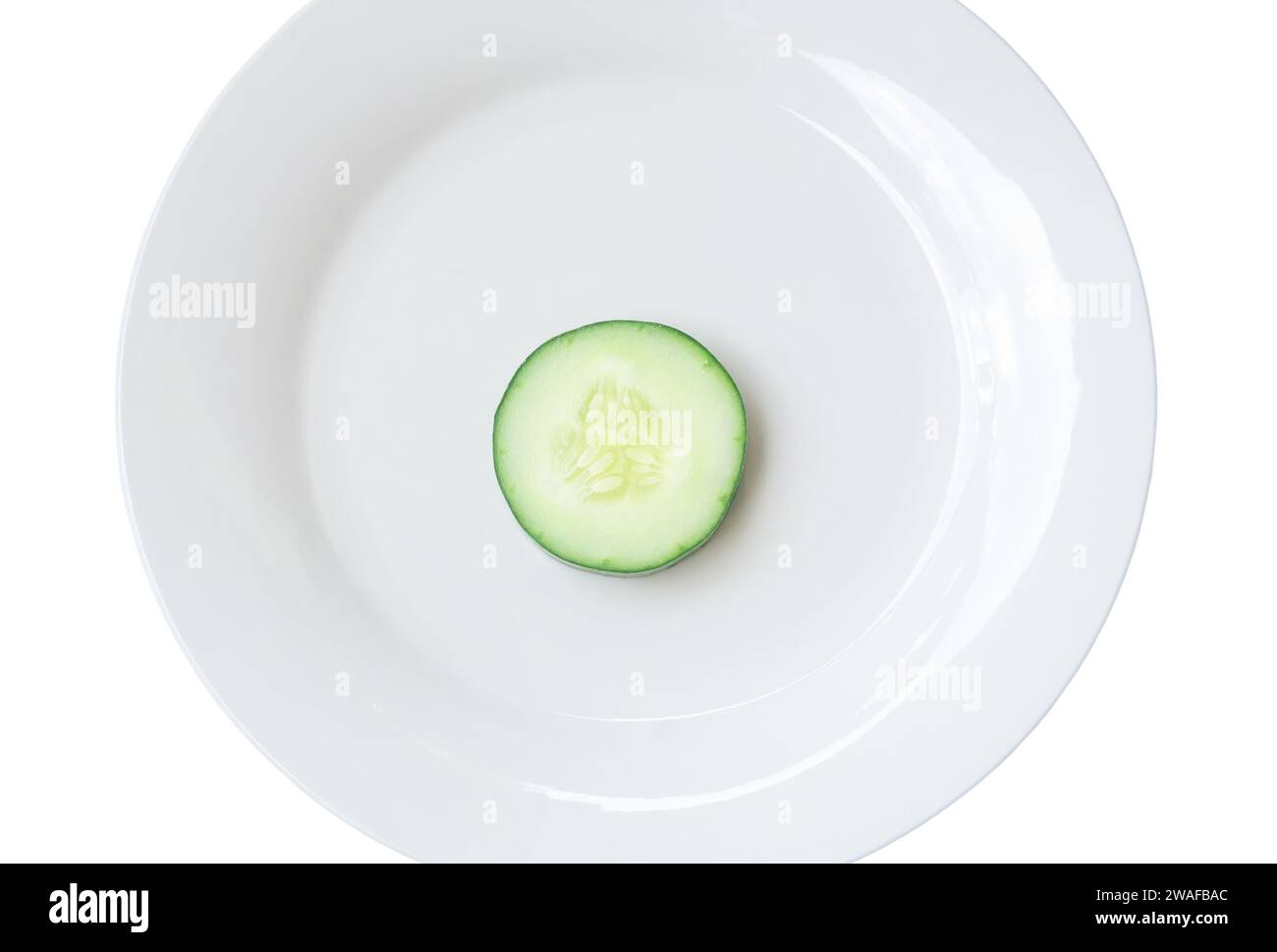 Top view of single fresh cucumber slice on white plate is isolated on ...