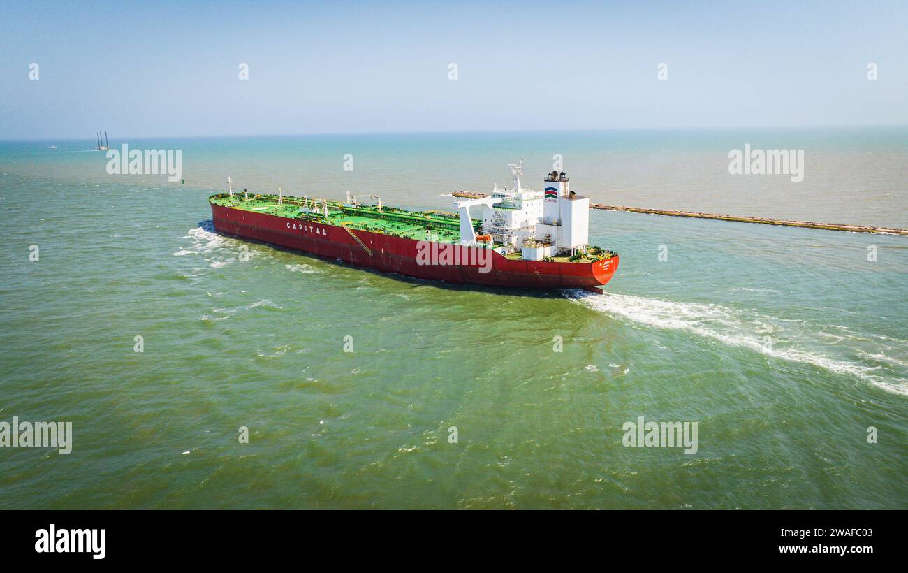 A Large Cargo Ship Sailing In The Open Waters Of The Texas Coast Port