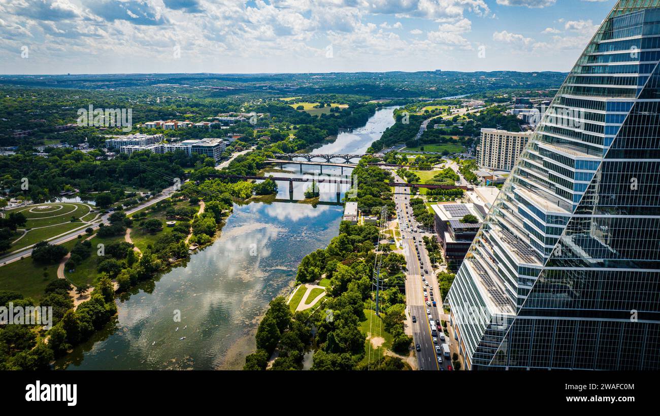 An aerial view of Austin with modern buildings and green trees along ...