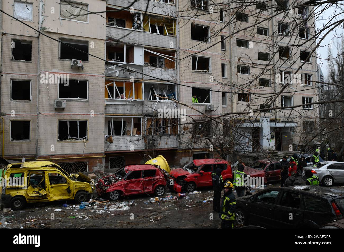 Rescuers are seen at the damaged multi-story residential building ...