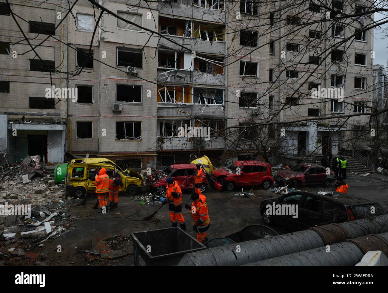 Rescuers are seen at the damaged multi-story residential building ...