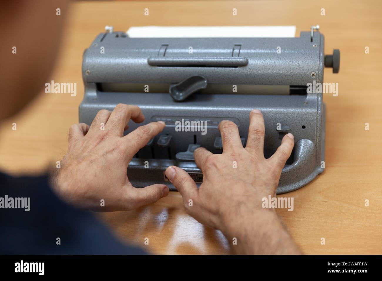 Blind or visually impaired person typing a Perkins Brailler Stock Photo - Alamy