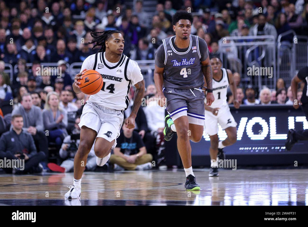 PROVIDENCE, RI - JANUARY 03: Providence Friars guard Corey Floyd Jr. (14) fast breaks pursued by ...