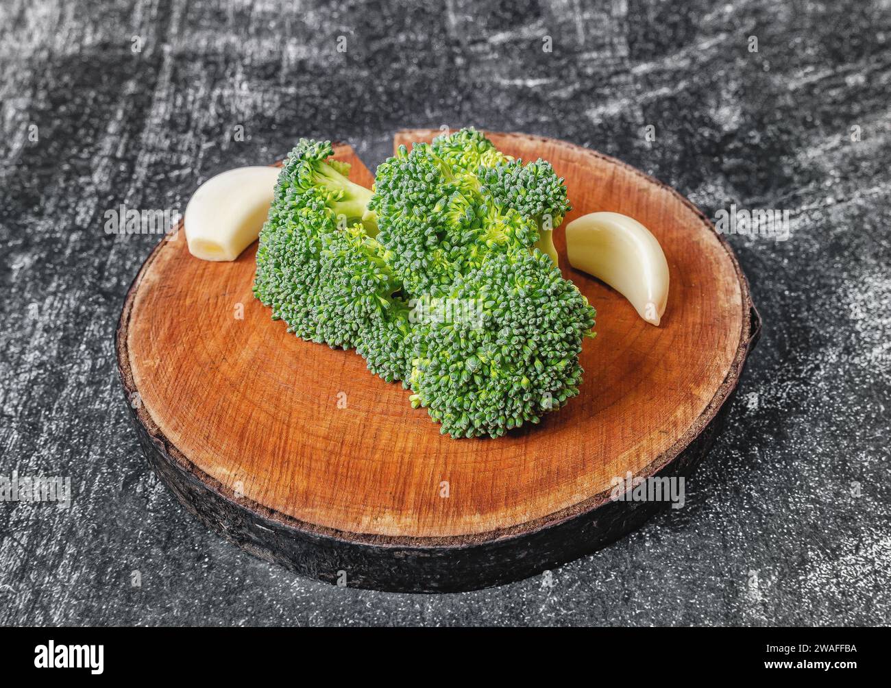 Green broccoli and garlic - still life image of food background. Wooden ...