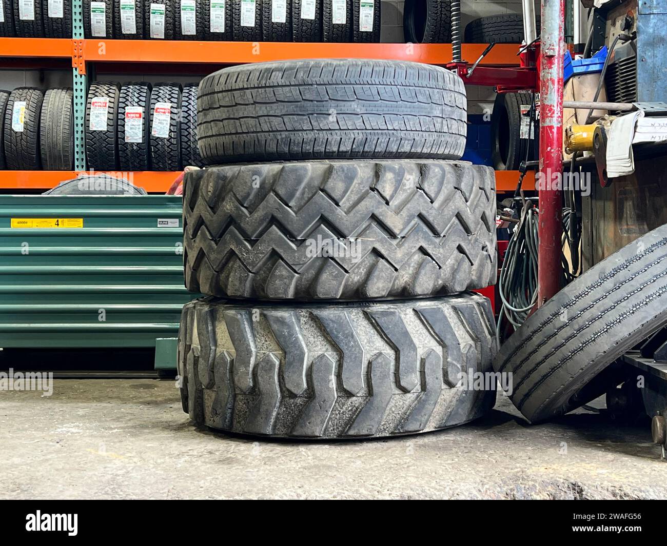 A stack of tires stacked in a workshop setting Stock Photo - Alamy