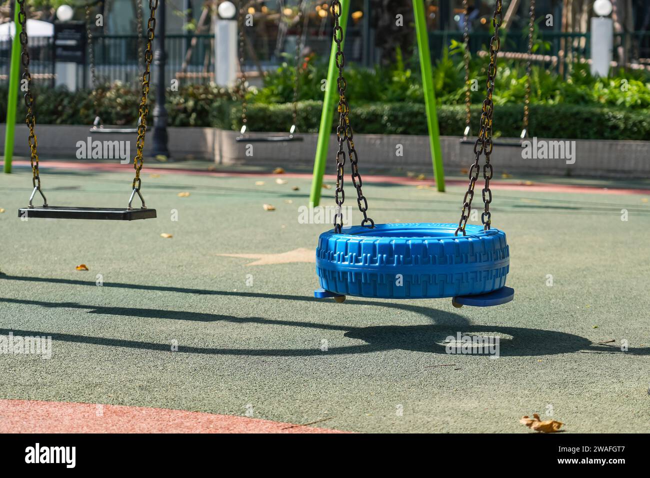 Blue wheel tire rubber swing on the playground in the courtyard of an ...