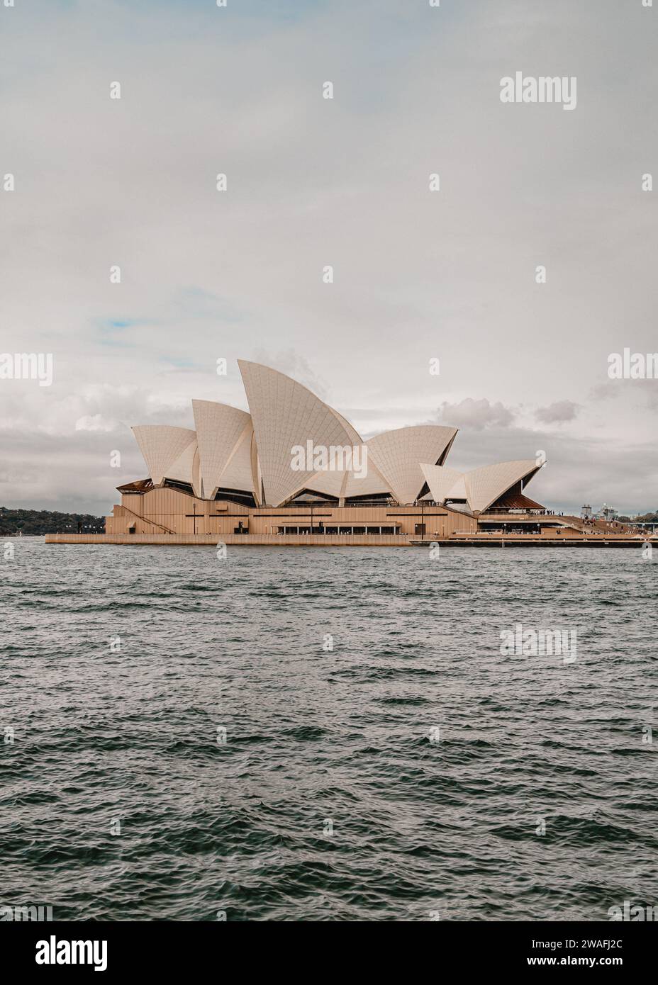 A scenic view of Sydney's iconic Opera Theatre on a cloudy day, with ...